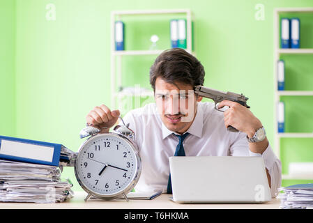 Despaired businessman thinking of suicide in the office Stock Photo - Alamy