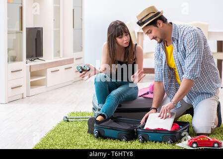 Young family packing for vacation travel Stock Photo - Alamy