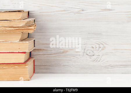 Home office workplace with stack of old books and headphones. With copy ...