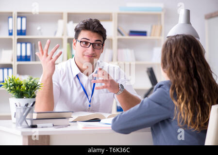 Sales assistant discussing transaction with customer Stock Photo - Alamy