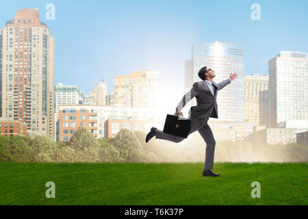 Happy businessman running towards his goal Stock Photo - Alamy