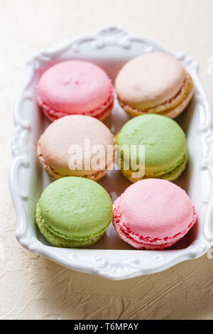Colourful macaroons on the plates Stock Photo - Alamy
