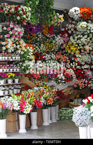 Fake flowers in flower pots for decoration Stock Photo - Alamy