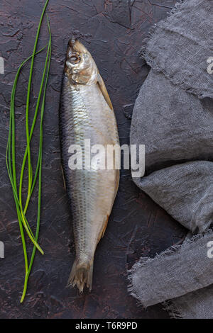 Raw whole salted herring fish served parsley Stock Photo - Alamy