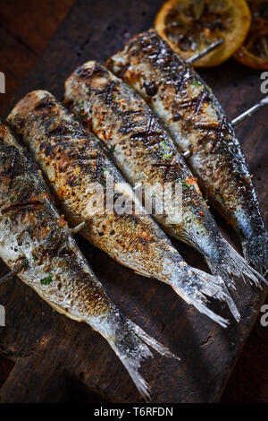 Grilled fish on metal skewers in close-up Stock Photo - Alamy