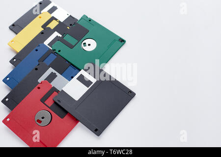 Multi-colored flexible disks isolated on a blue background. Copy space ...