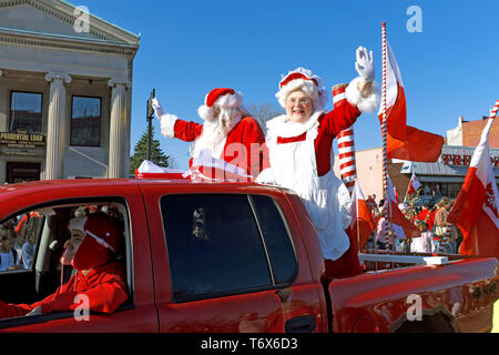 Santa Claus and Mrs Claus ride in on an antique 1960 fire truck at a ...