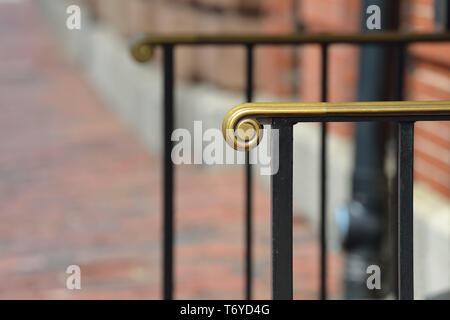 Handrail end scroll, polished brass. Detail of rail cap volute, golden ...