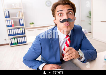The funny bisinessman with fake moustache in the office Stock Photo - Alamy