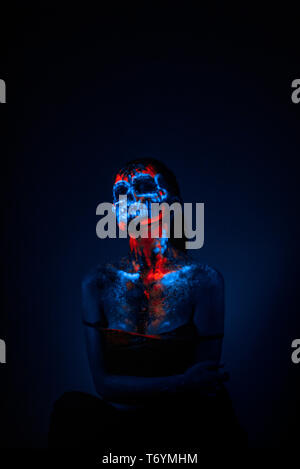 Girl's face painted UV skull Stock Photo - Alamy