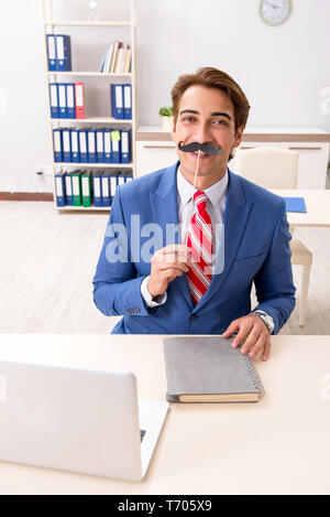 The funny bisinessman with fake moustache in the office Stock Photo - Alamy