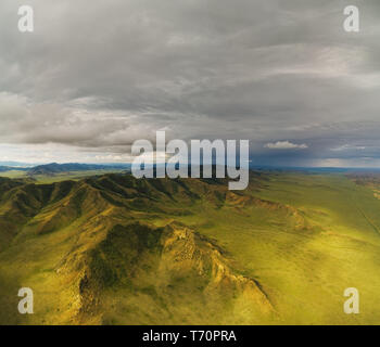 Mongolian mountain natural landscape with shadows from clouds near lake ...