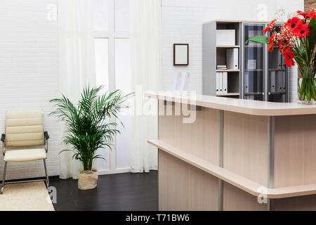 reception desk and bookcase in a modern office Stock Photo - Alamy