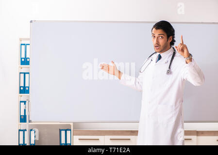 Young doctor in front of whiteboard Stock Photo - Alamy