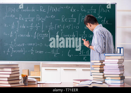 Young male student studying math at school Stock Photo - Alamy