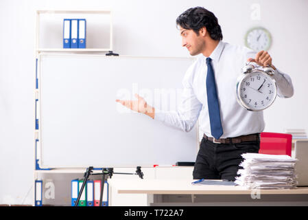 Young handsome financial speciaist in front of white board Stock Photo ...