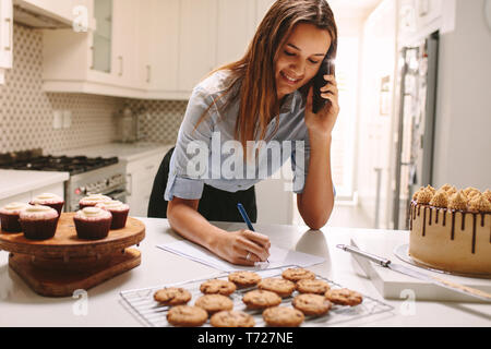 Chef kitchen taking notes Stock Photo - Alamy