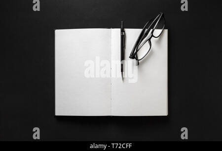 Black book with glasses and pen Stock Photo - Alamy