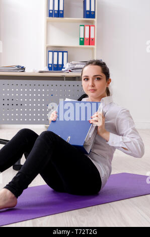 Female employee doing sport exercises in the office Stock Photo - Alamy