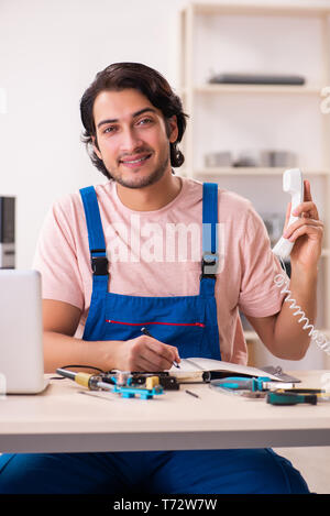 engineer taking notes while fixing a computer Stock Photo - Alamy