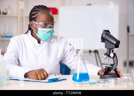 Young black chemist working in the lab Stock Photo - Alamy
