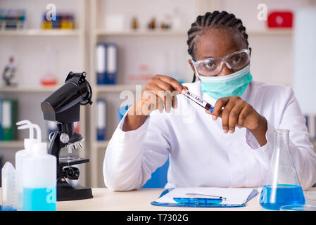 Young black chemist working in the lab Stock Photo - Alamy