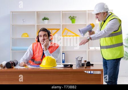 Two engineers colleagues working under project Stock Photo - Alamy