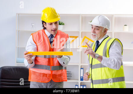 Two engineers colleagues working under project Stock Photo - Alamy