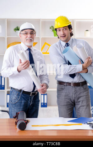 Two engineers colleagues working under project Stock Photo - Alamy
