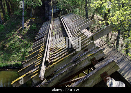 Old destroyed railway bridge over the river. Railway crossing blown up ...