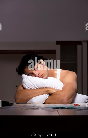 Young man calculating expences night at home Stock Photo - Alamy