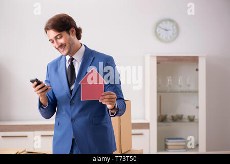 The young handsome realtor selling flat Stock Photo - Alamy