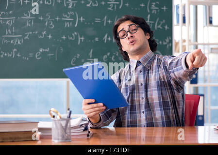 Young funny math teacher in front of chalkboard Stock Photo - Alamy