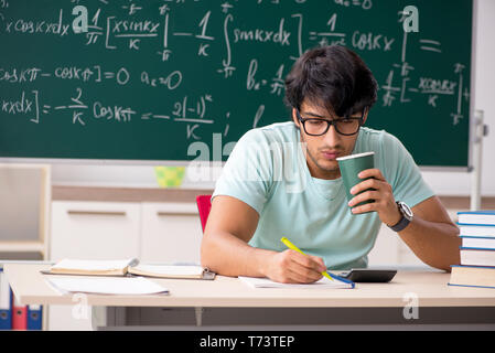 Young male student mathematician in front of chalkboard Stock Photo - Alamy