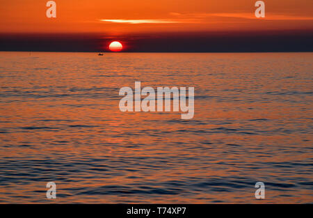 21 April 2019, Denmark, Klitmöller: Surfers are waiting for a wave in ...