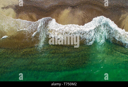 21 April 2019, Denmark, Klitmöller: Surfers are waiting for a wave in ...