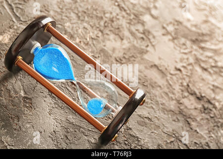 Hourglass on grey textured background. Time management concept Stock ...