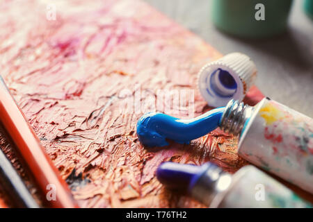 Closeup of different paint tubes on a table Stock Photo - Alamy