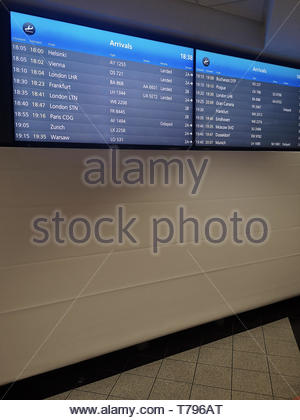 Airport electronic arrivals board showing one early flight among on ...