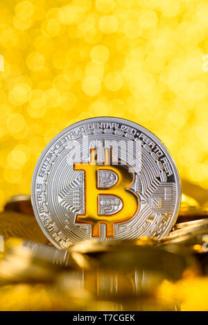 A golden bitcoin coin stands on a grungy wooden surface. World ...