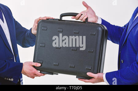 Business transfer deal. Handover of black suitcase in hands of partners ...