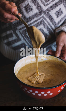 Female person making fresh waffles with a waffle maker towards black on ...