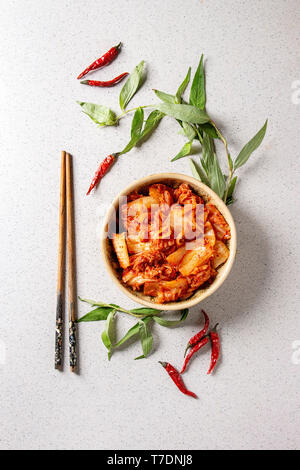 Kimchi cabbage in bowl with chopsticks for eating on wooden background ...