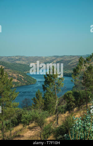 Tejo River valley with hills covered by undergrowth and industry on ...