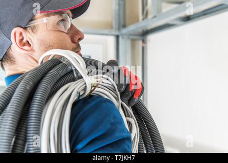electrician with cable and pipes Stock Photo - Alamy