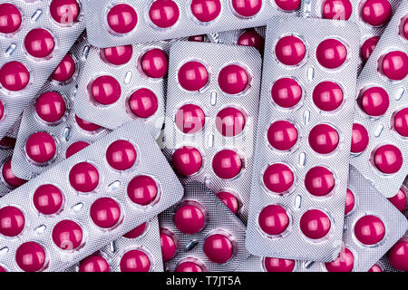 Ibuprofen in pink tablet pills pack in blue blister pack isolated on ...