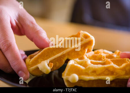 woman hands prepare waffle for serving process.waffle made from dough ...