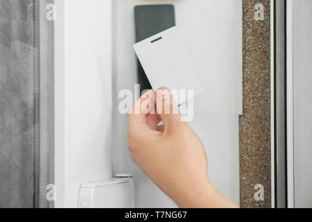 Man opening door with security card outdoors Stock Photo - Alamy