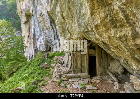 Primitive mountain shelter built under rock face Stock Photo - Alamy
