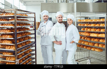 A group of bakers smiles at the bakery Stock Photo - Alamy